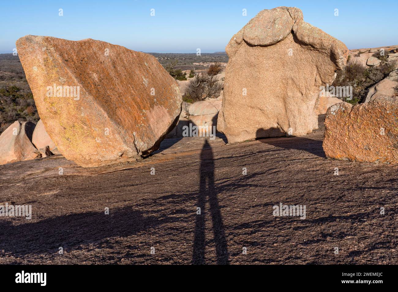 Hiker's shadow from sunlight, near boulders on summit trail in Texas ...