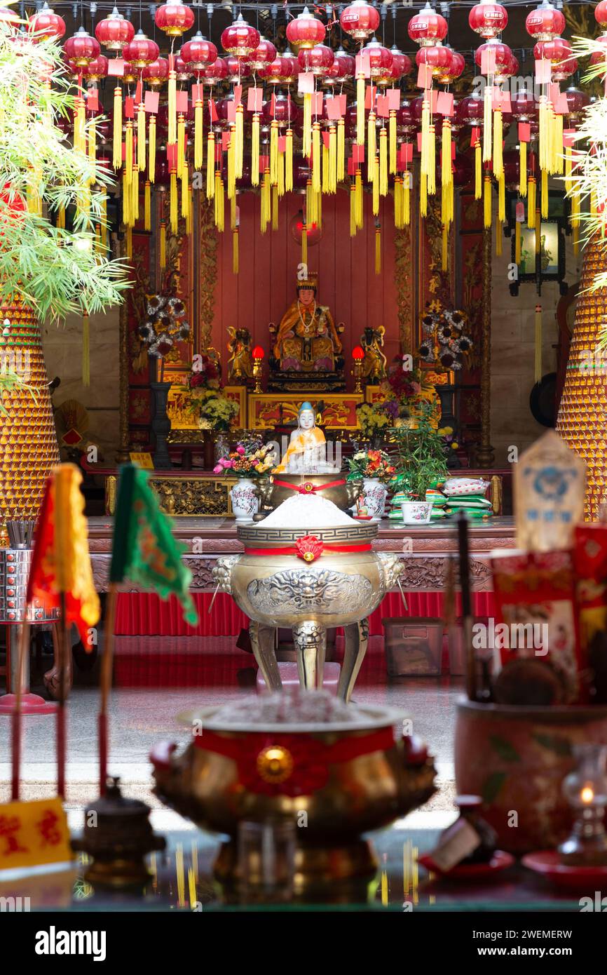 Buddhist shrine adorned with red lanterns, and offerings Stock Photo ...
