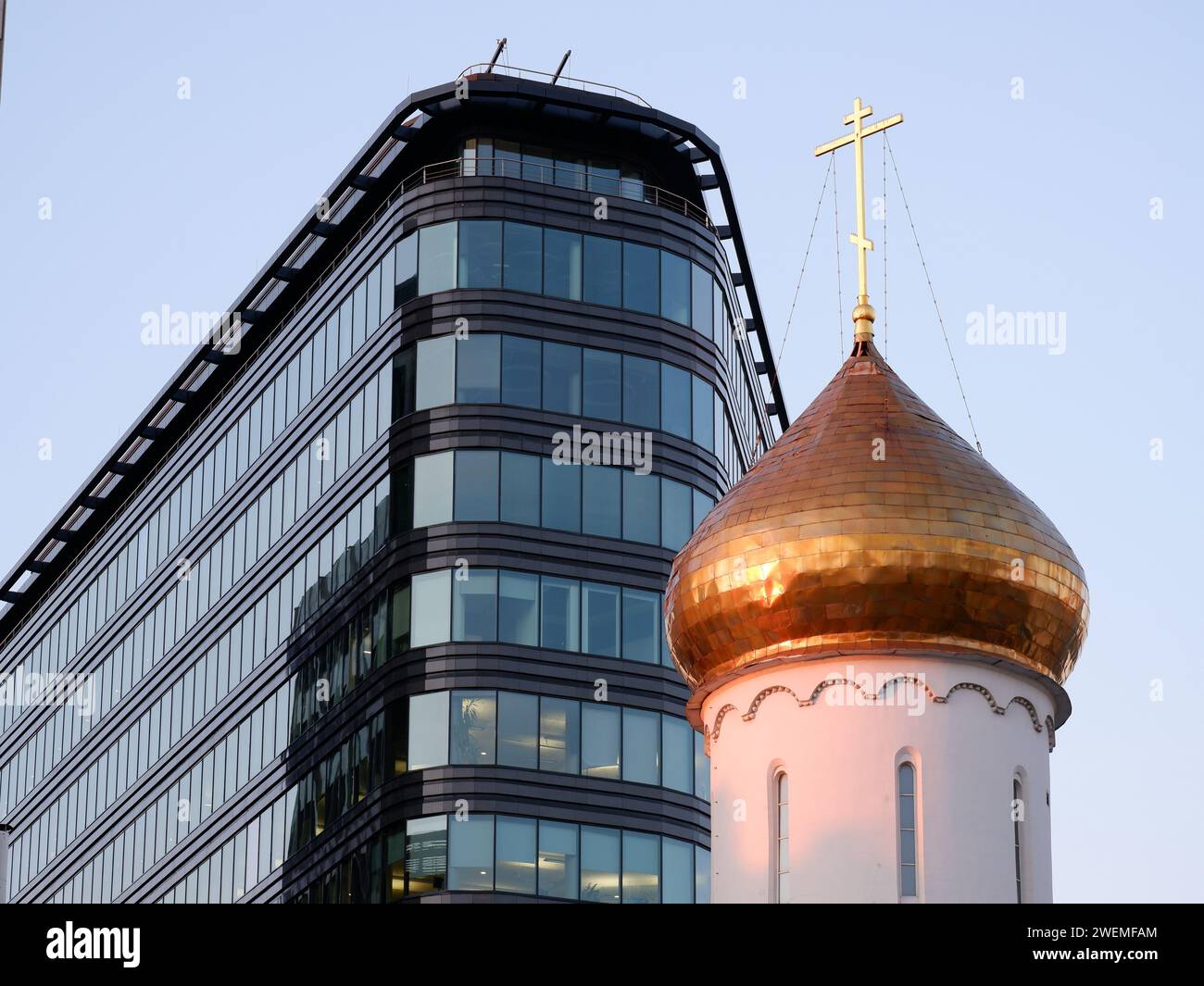 An Orthodox church against the background of a modern building Stock ...