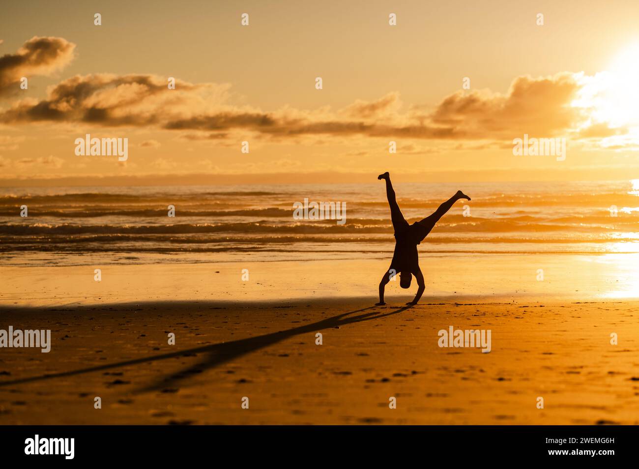 Doing handstand sunset hi-res stock photography and images - Alamy