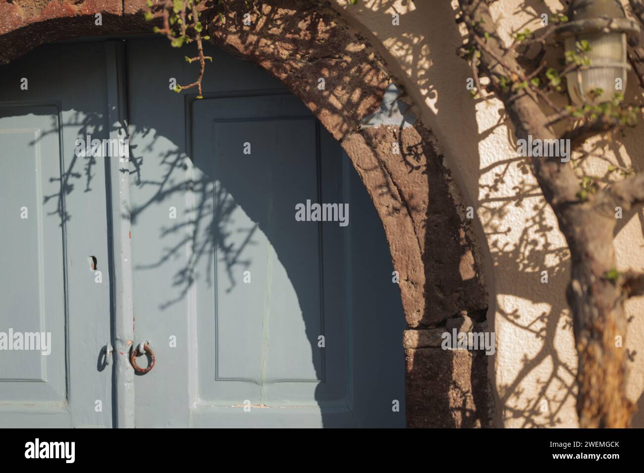 Close up of arched doorway entrance with tree and sunlight Stock Photo ...