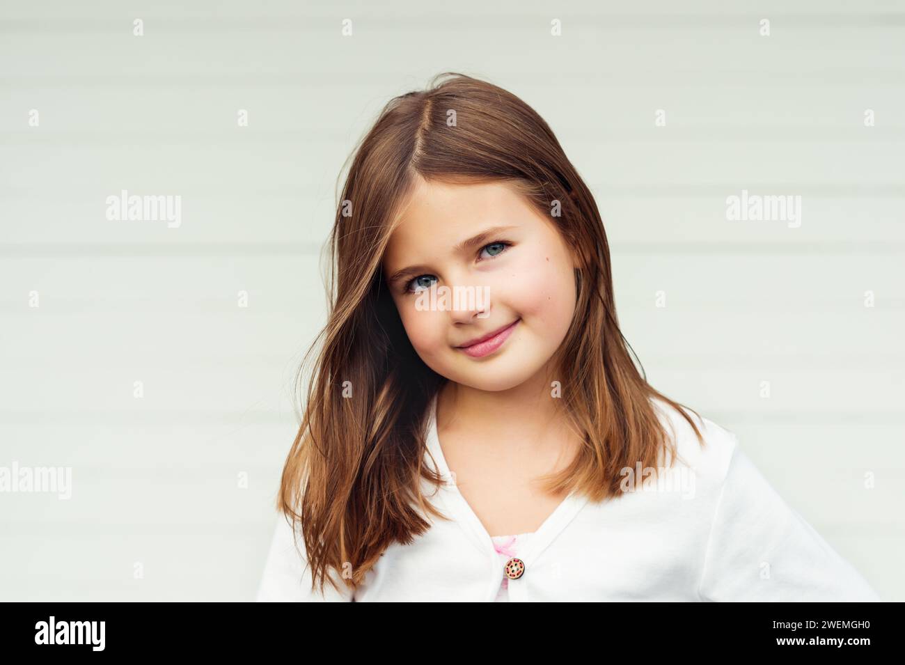 Outdoor portrait of cute little 8-9 year old girl with brown hair ...