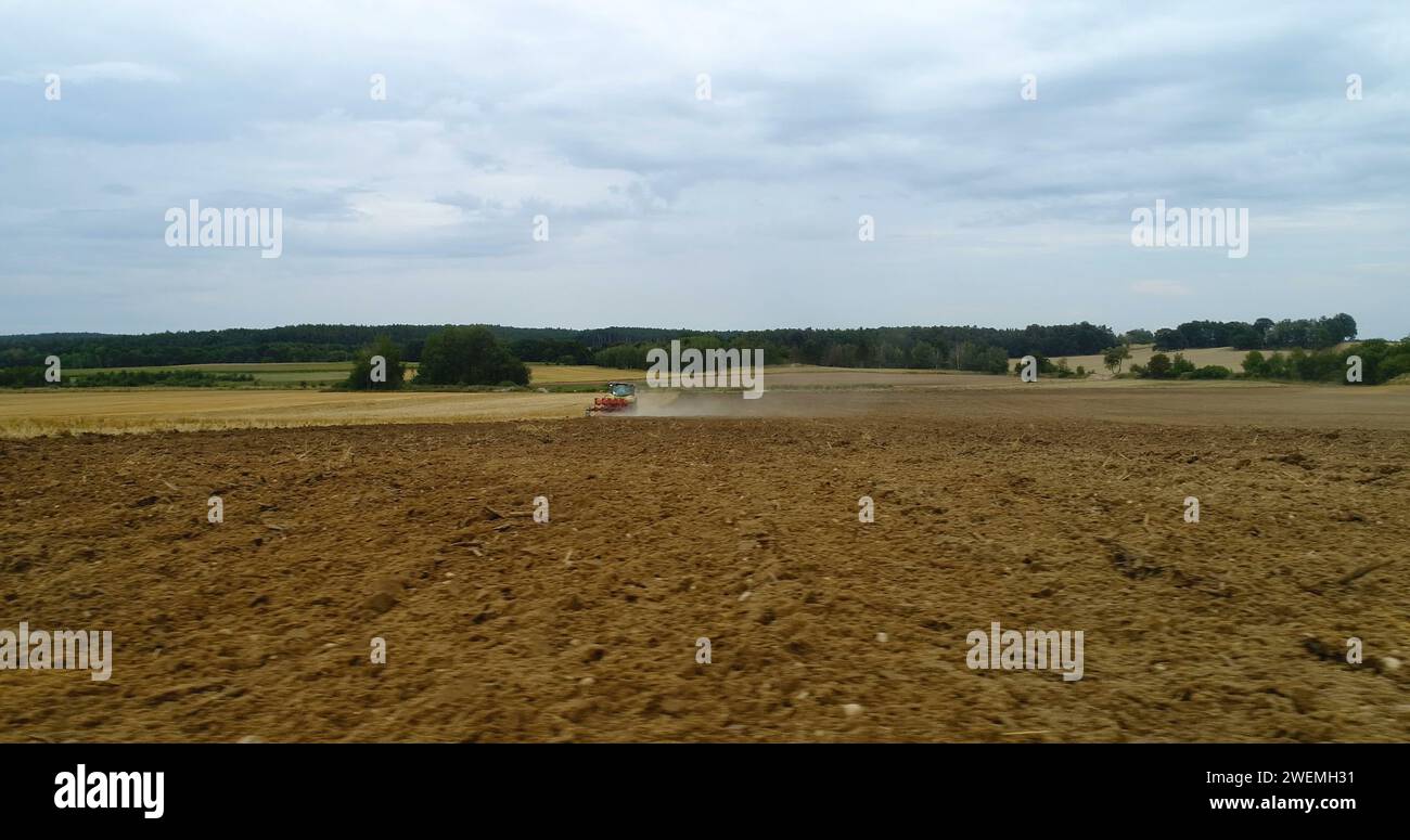 Tractor sowing field - 4K Stock Photo - Alamy