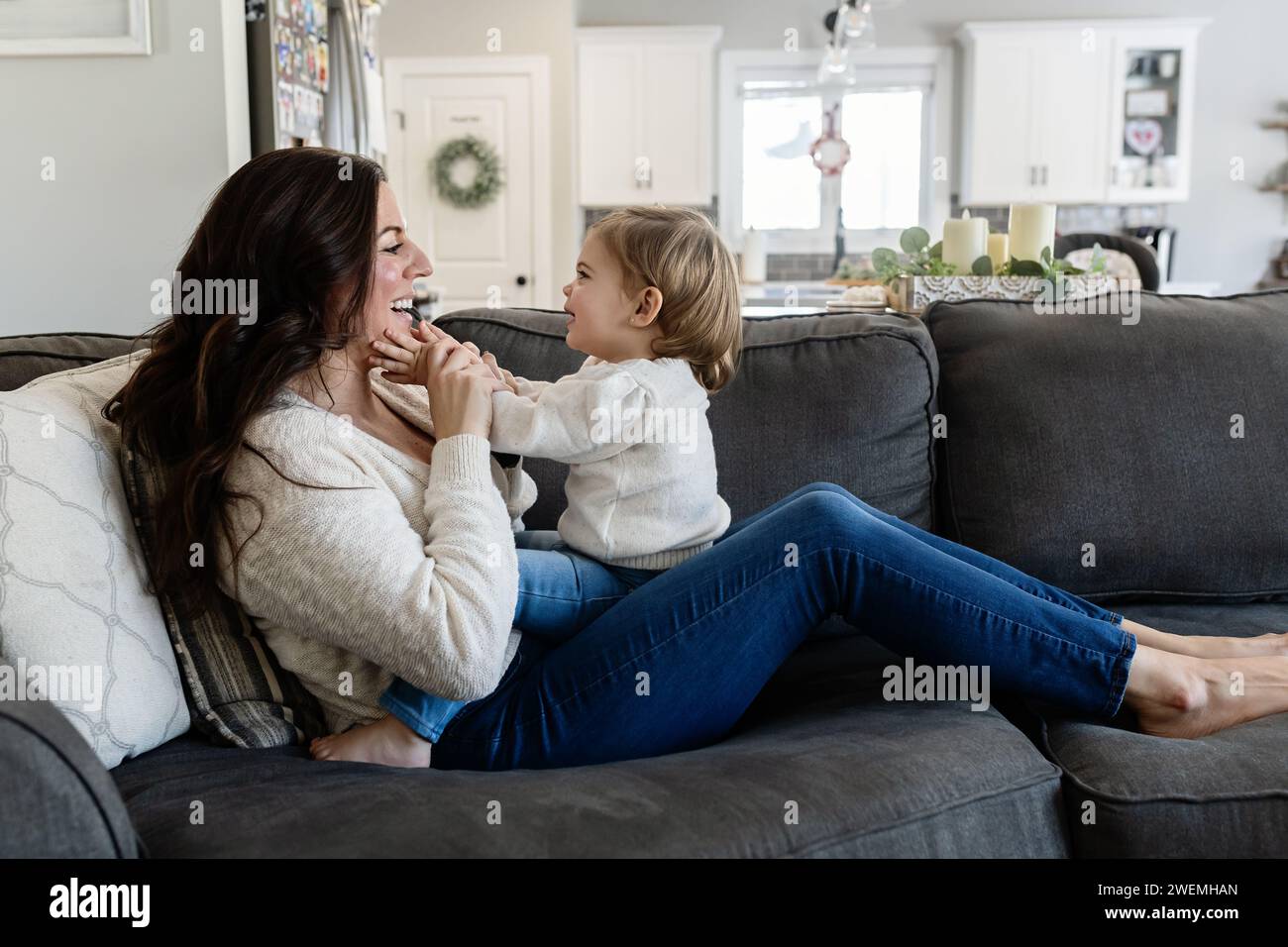 Laughing together on cozy couch hi-res stock photography and images - Alamy