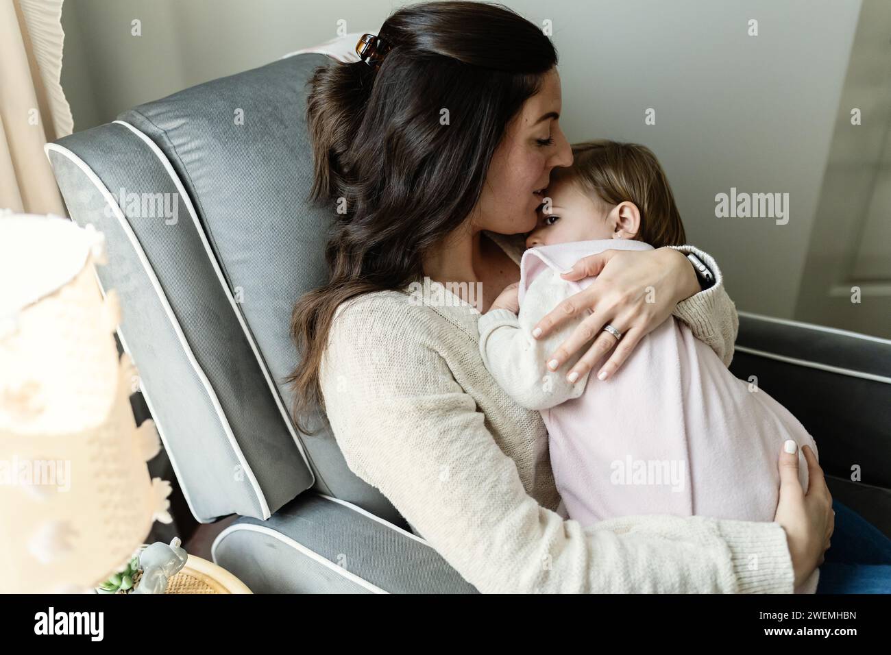 Mother rocking her child before nap time Stock Photo - Alamy