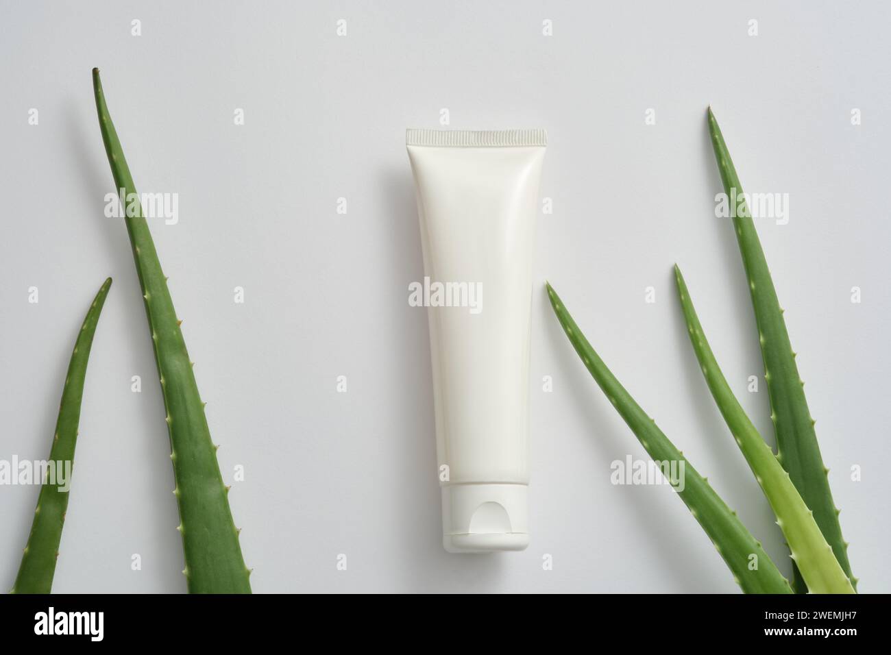 White plastic tube unlabeled with facial moisturizer cream or facial ...