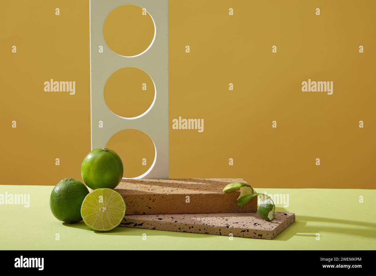 Minimal scene with stacked of rectangle brick, fresh limes and ...