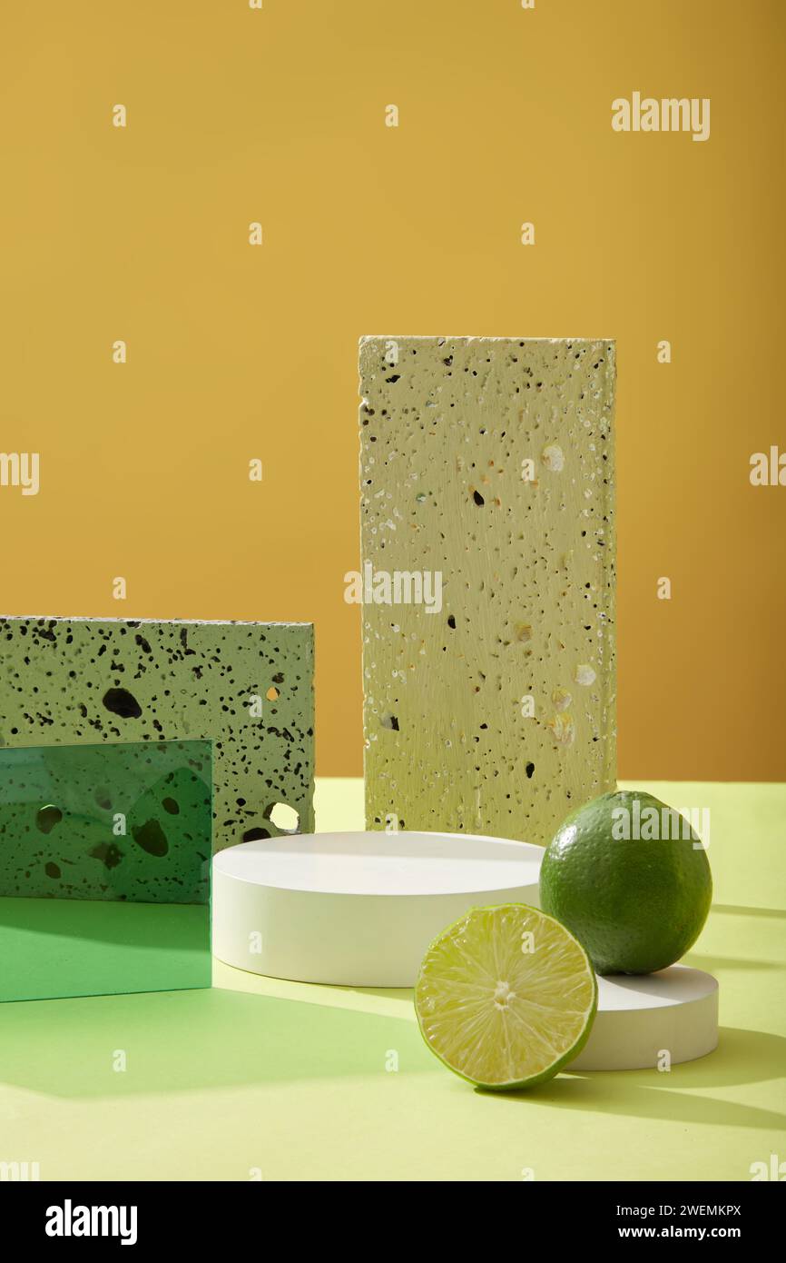 Halves of lime decorated on yellow background with rectangle bricks and ...