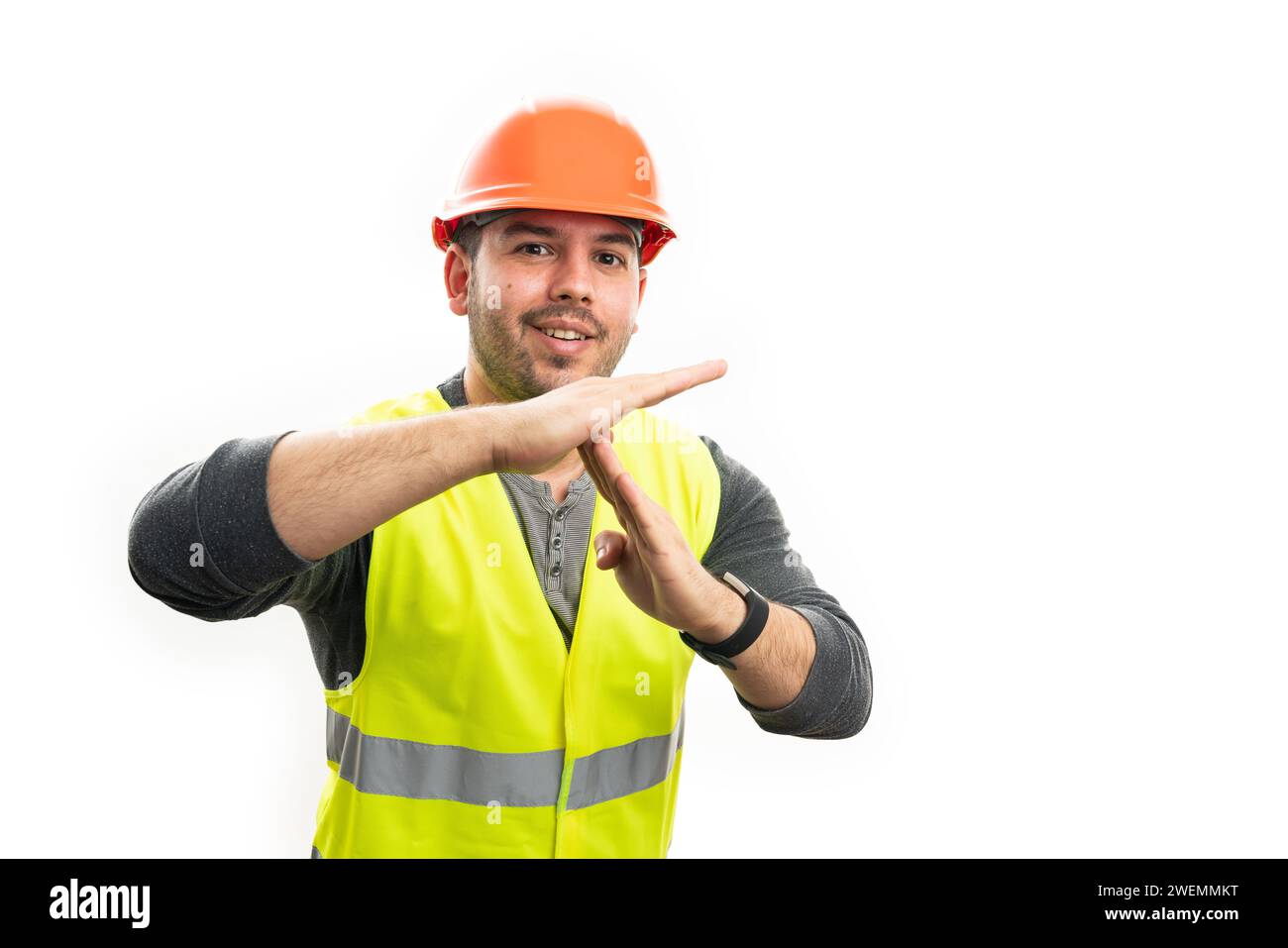 Constructor adult man making timeout pause gesture with smiling ...