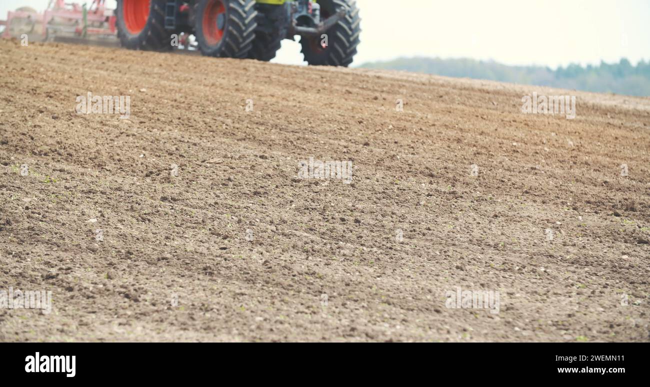 Tractor plowing field. Agriculture background Stock Photo - Alamy