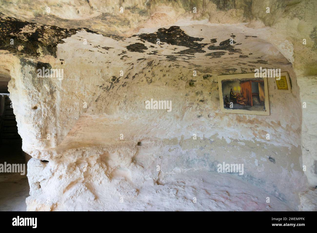 A rock cave with a mural and an information panel, abbot's cell, Aladja ...