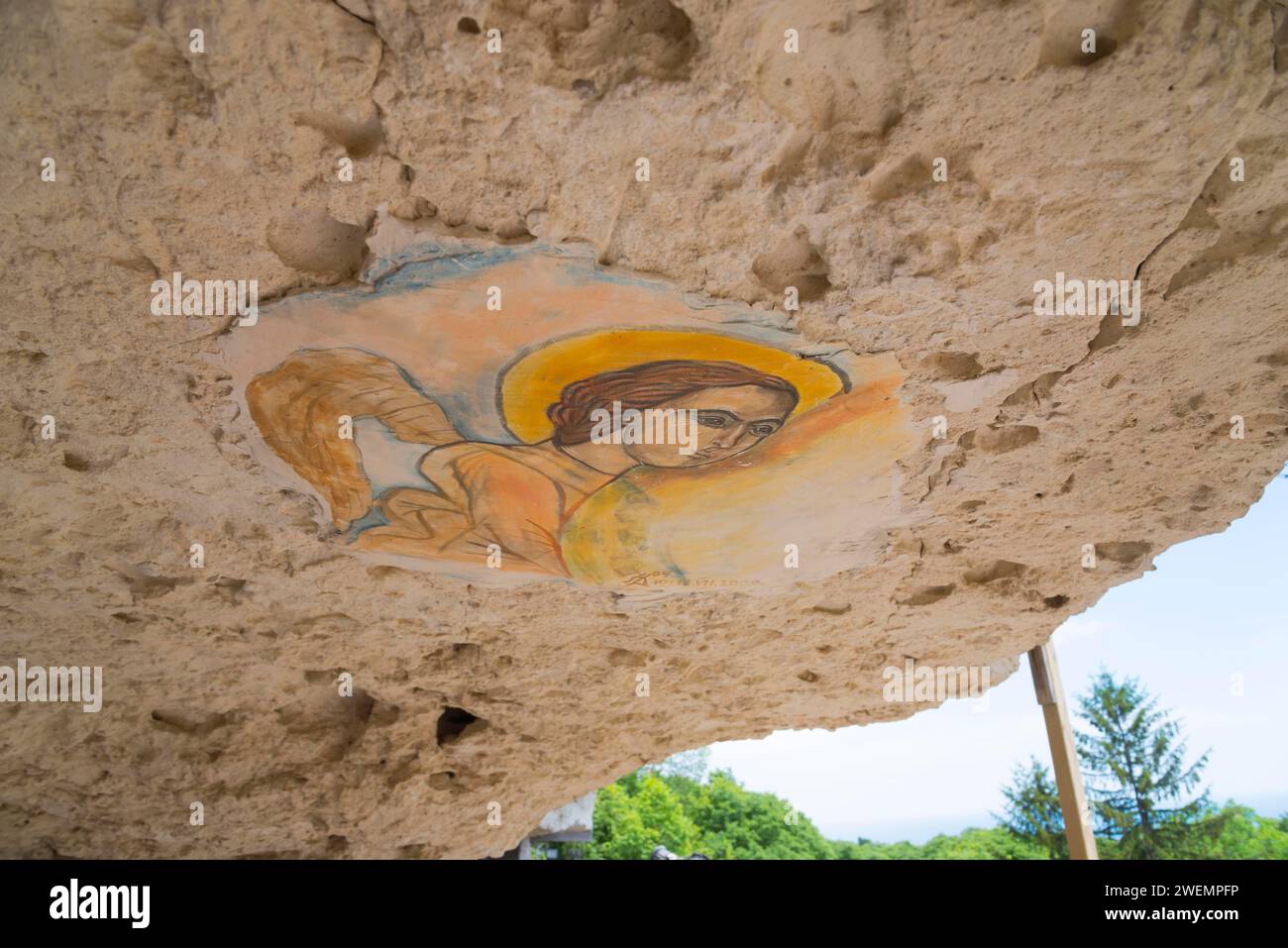 A ceiling fresco of an angel in a cave damaged by erosion, ceiling ...