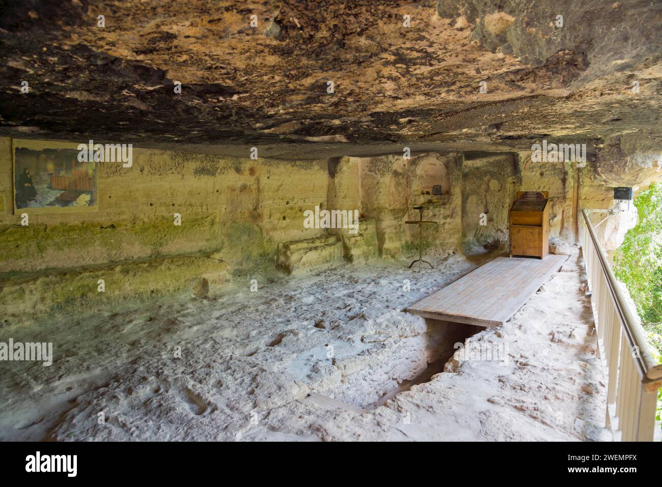 Interior view of a cave with frescoes and wooden structures, church ...