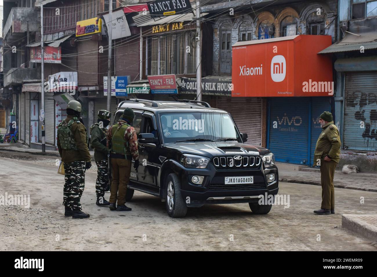 Government forces stop a vehicle near a temporary check-post during ...