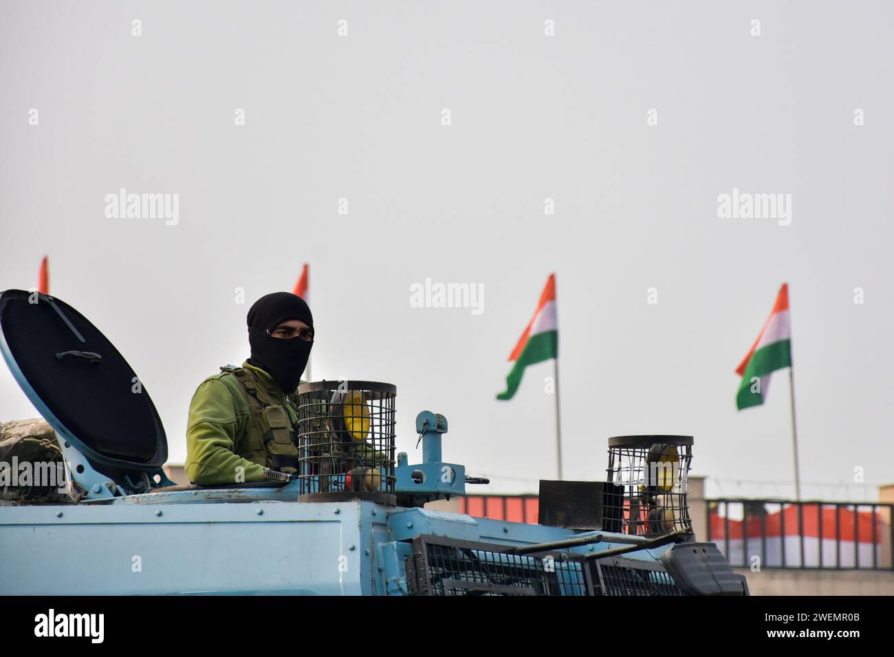 A paramilitary trooper keeps vigil from the top of an armored vehicle ...