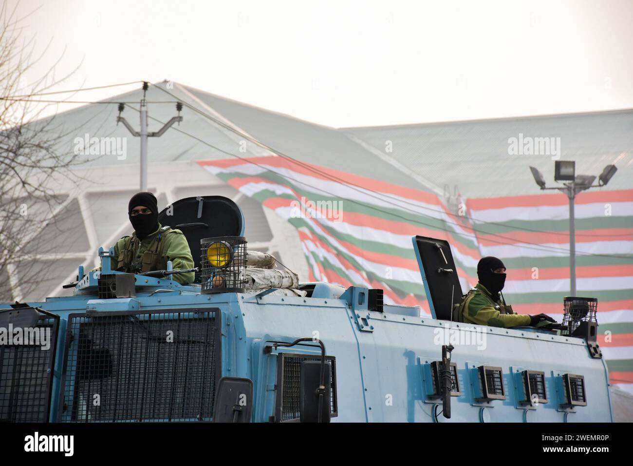 Paramilitary troopers keep vigil from the top of an armored vehicle ...