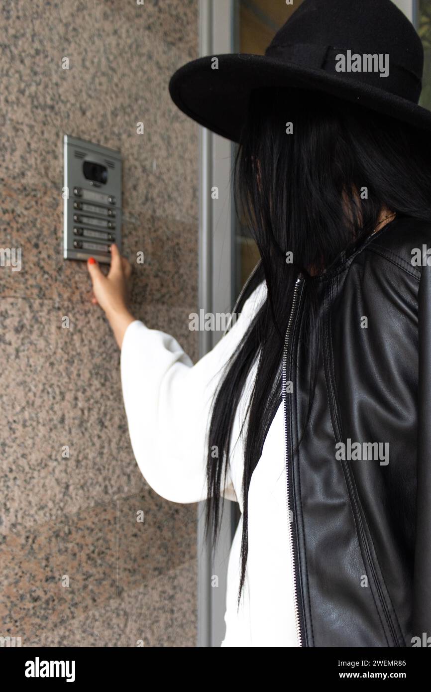 Vertical Side view of unrecognizable woman wearing a hat pushing the ...