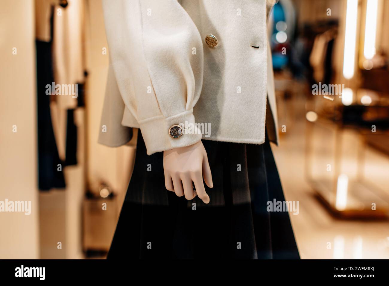 Fancy details of a classic white jacket with golden buttons and black ...