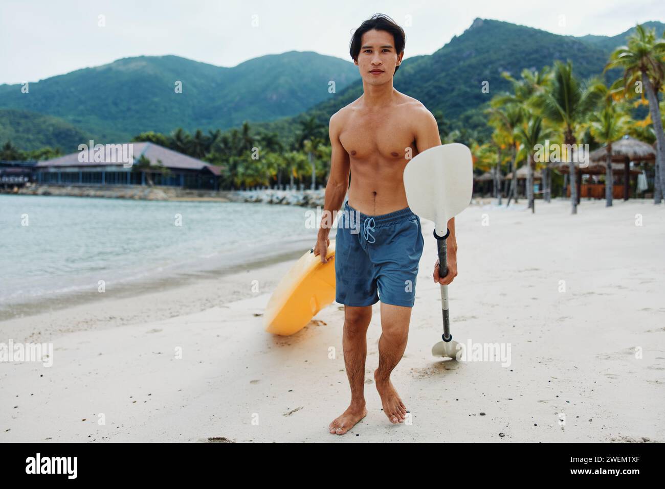 Kayak Man Gliding On the Beach: A Joyful Asian Vacationer Embracing the ...