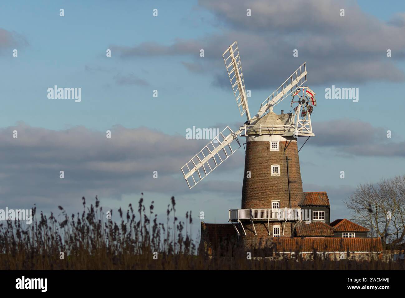 Windmill with a blue sky and white clouds behind, Cley-next-to-the-sea ...