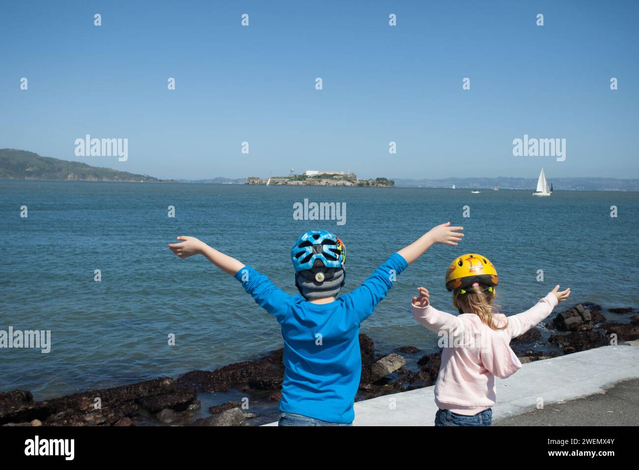 Mother and children on a park bench overlooking the pacific in San ...