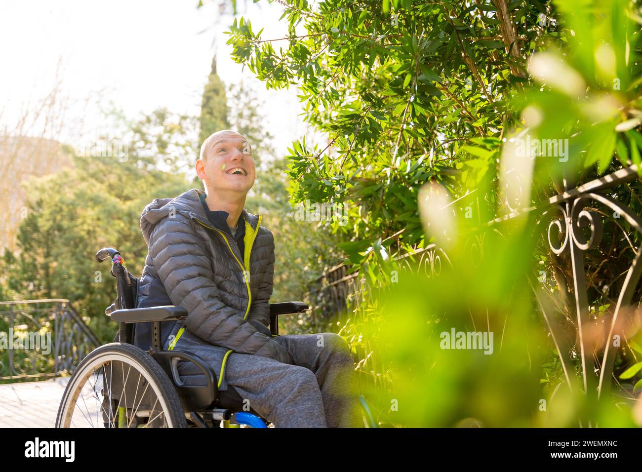 Portrait with focus and copy space of a happy disabled man gazing the ...