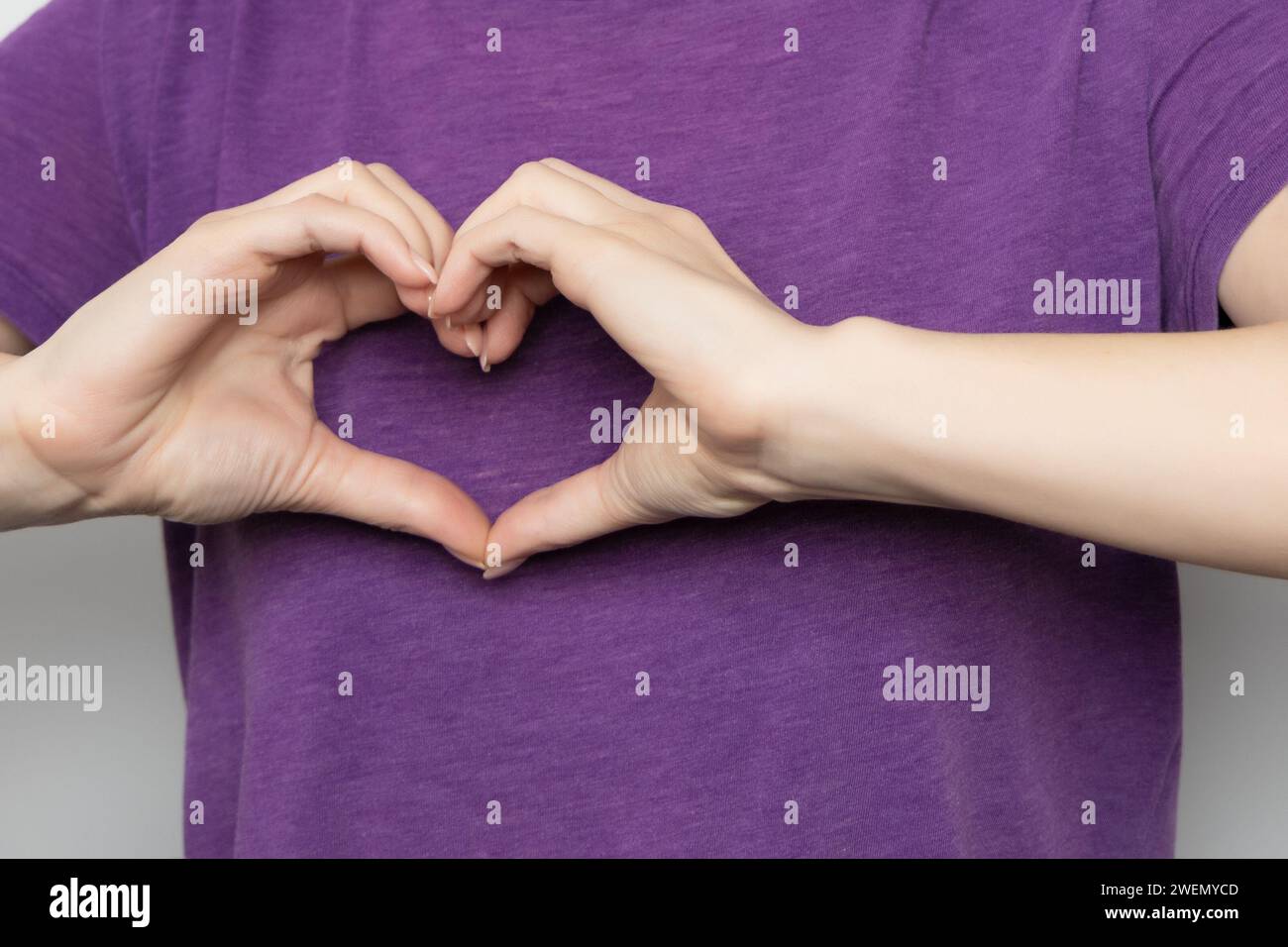 Inspire inclusion. Woman holding her hands in the shape of a heart and ...