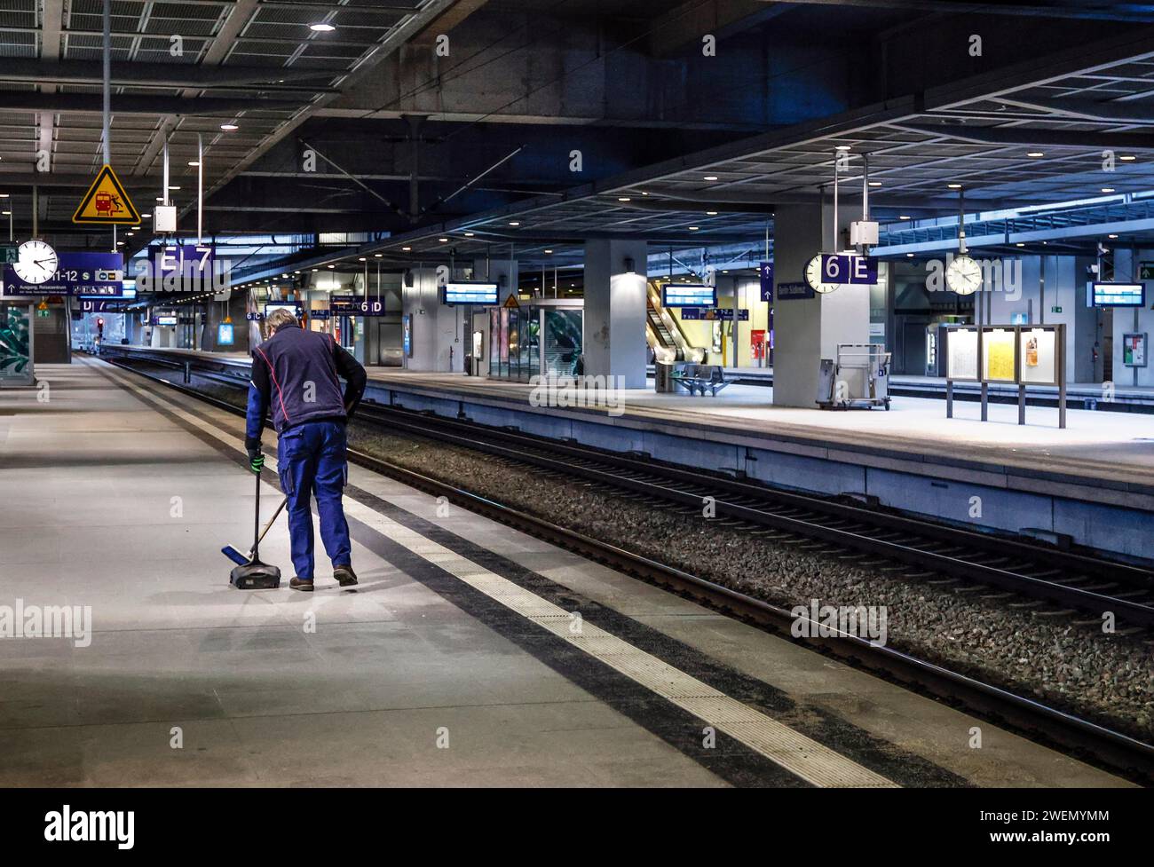 A Deutsche Bahn service employee cleans the platform at Suedkreuz ...