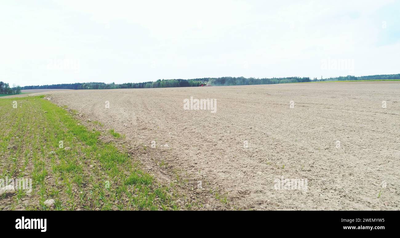 Tractor plowing field. Agriculture background Stock Photo - Alamy