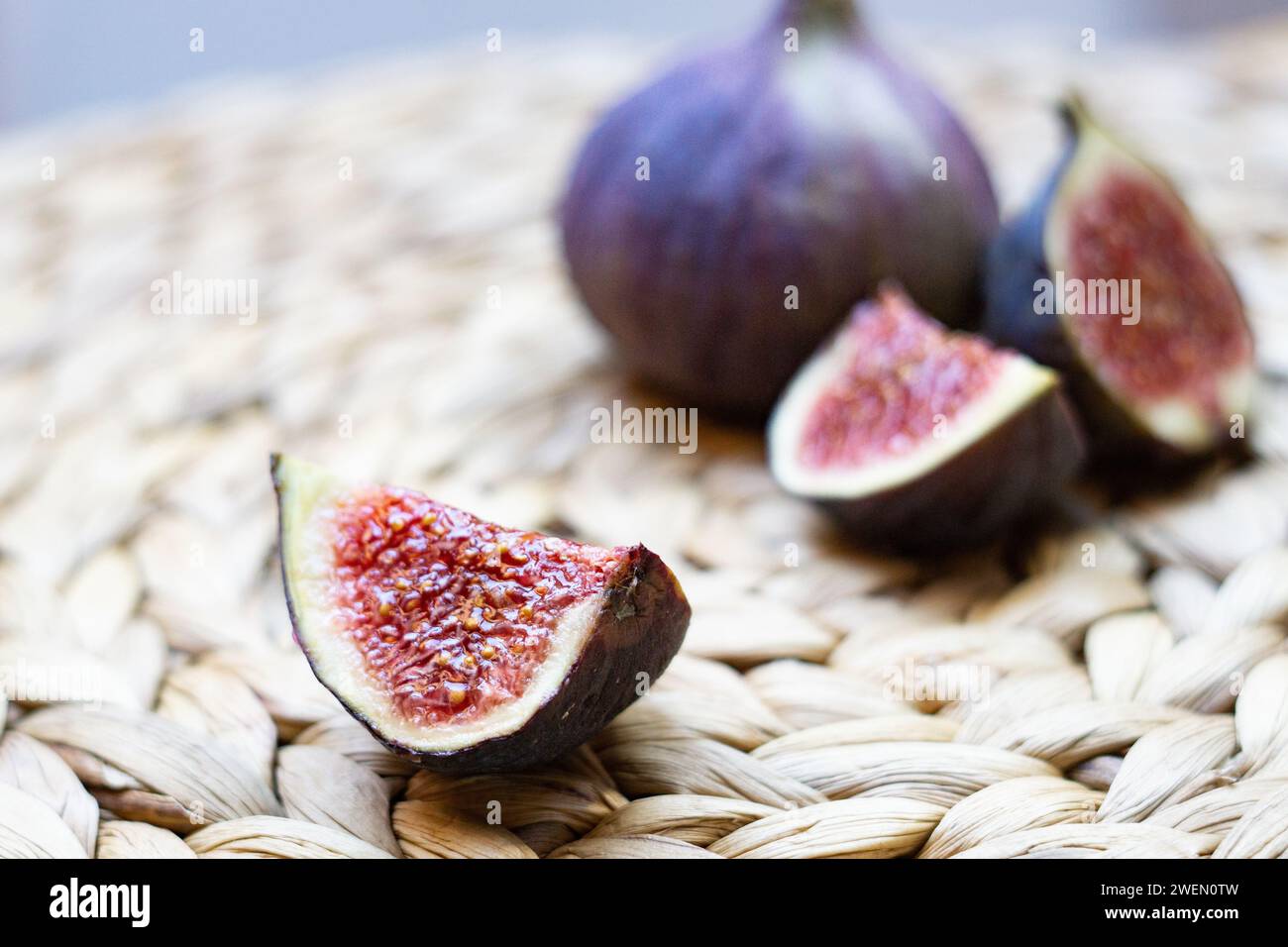 Still life of Fresh Figs lying on a plate with yellow edges, whole and ...