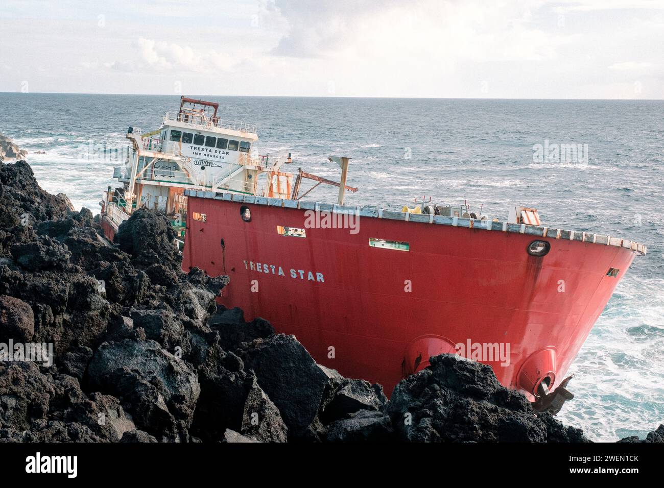 The shipwreck of the Tresta Star boat, a large red vessel, rests on top ...