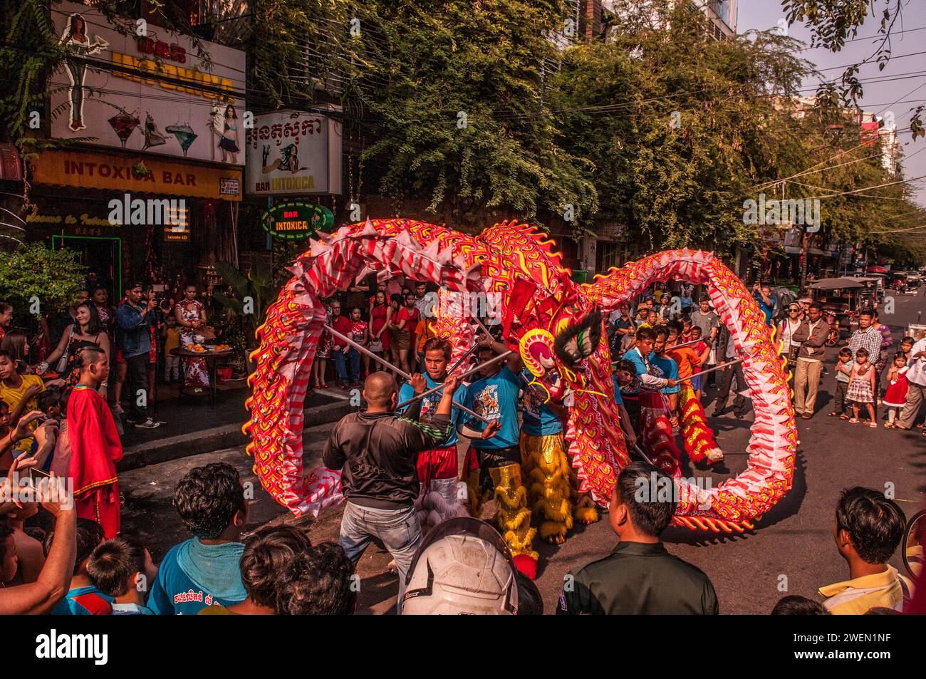 a crowd watches traditional "dragon dancing" during Chinese New Year ...
