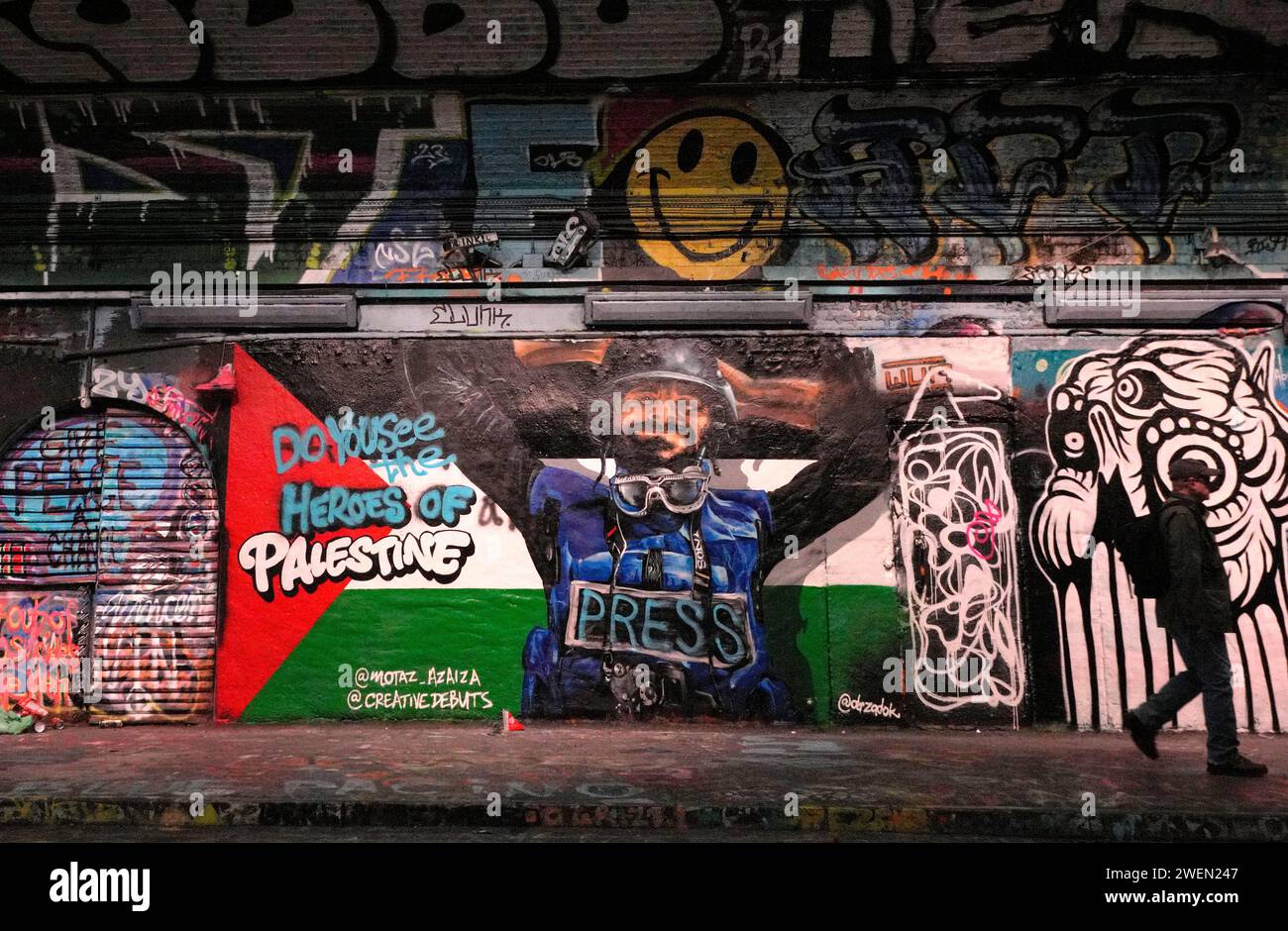 A pedestrian walks past graffiti in Leake Street railway arches, where ...