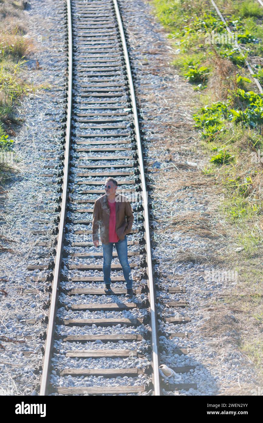 lonely man standing on railroad tracks Stock Photo - Alamy