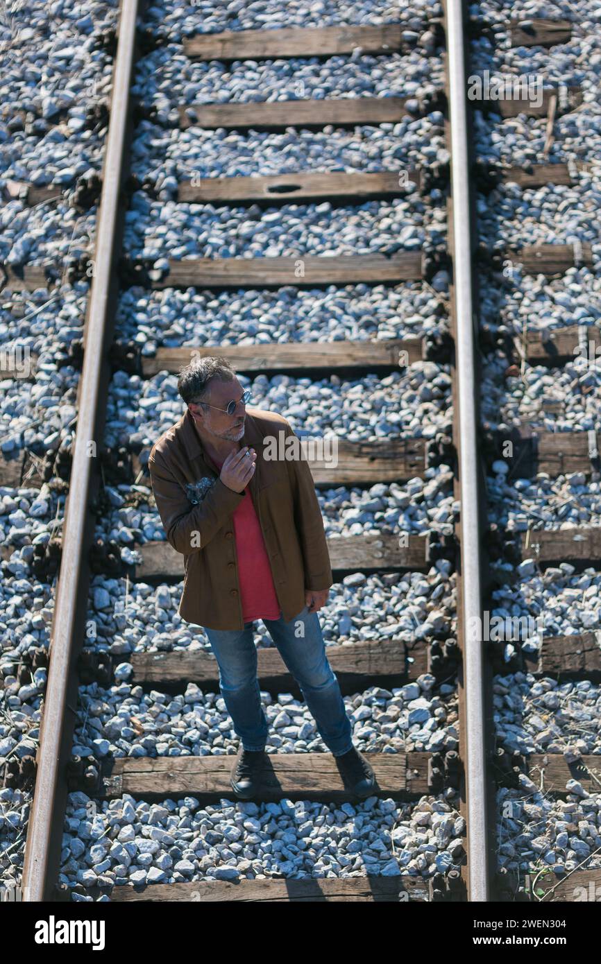 Man walking on railroad tracks hi-res stock photography and images - Alamy