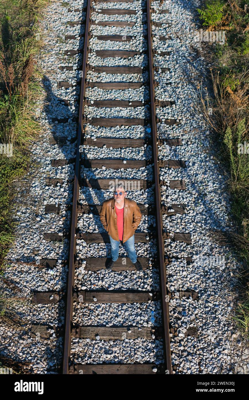single man standing on railroad tracks Stock Photo - Alamy