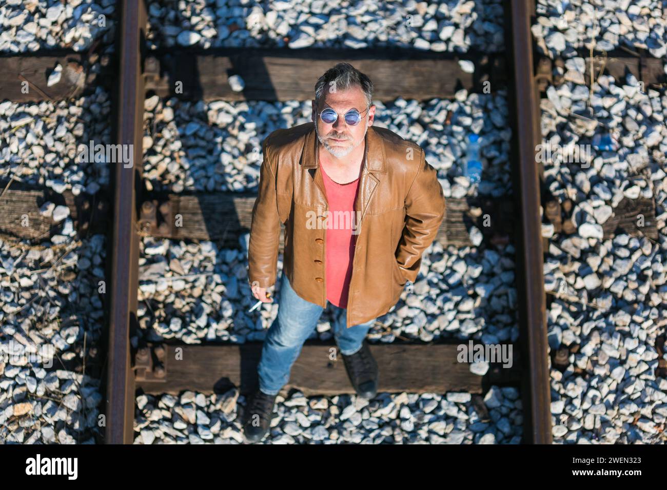 lonely man standing on railroad tracks Stock Photo - Alamy