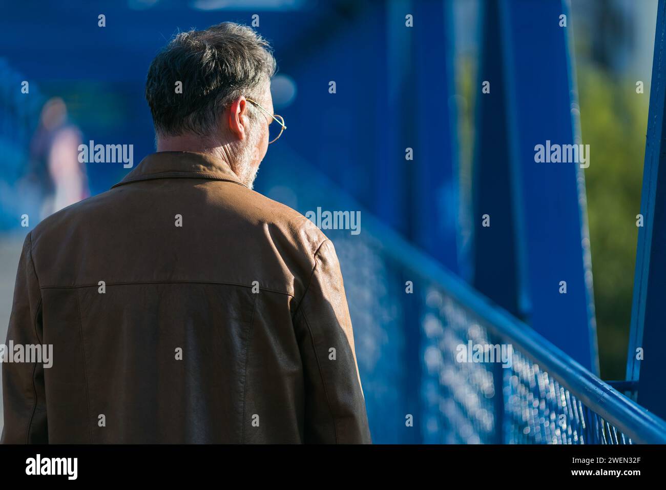 lonely man walking and looking down from the bridge Stock Photo - Alamy
