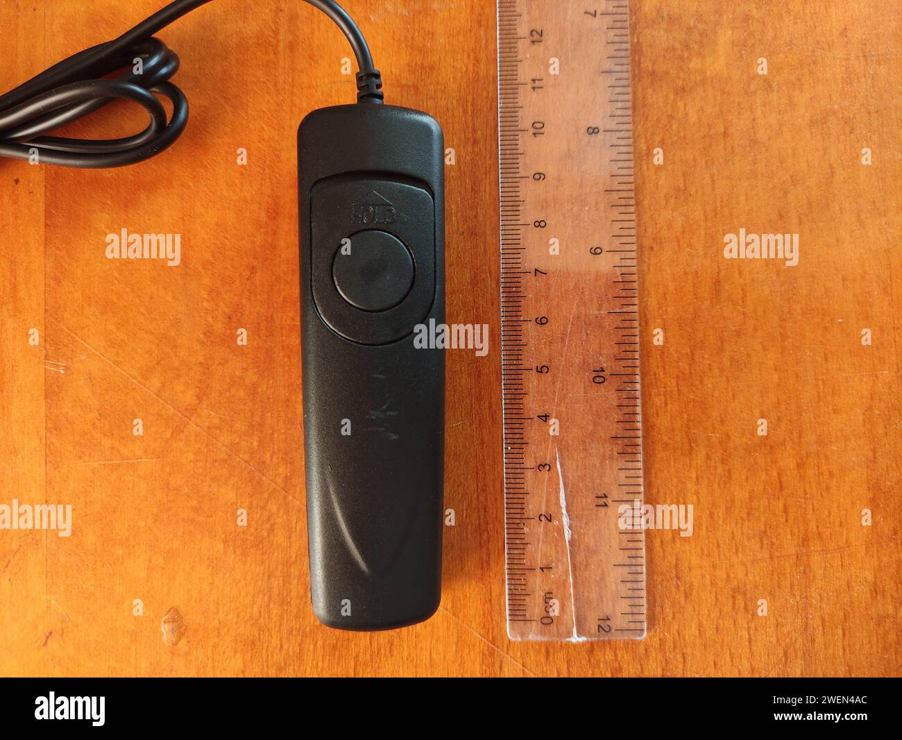 Wired remote control to control the camera on the wooden background and ...