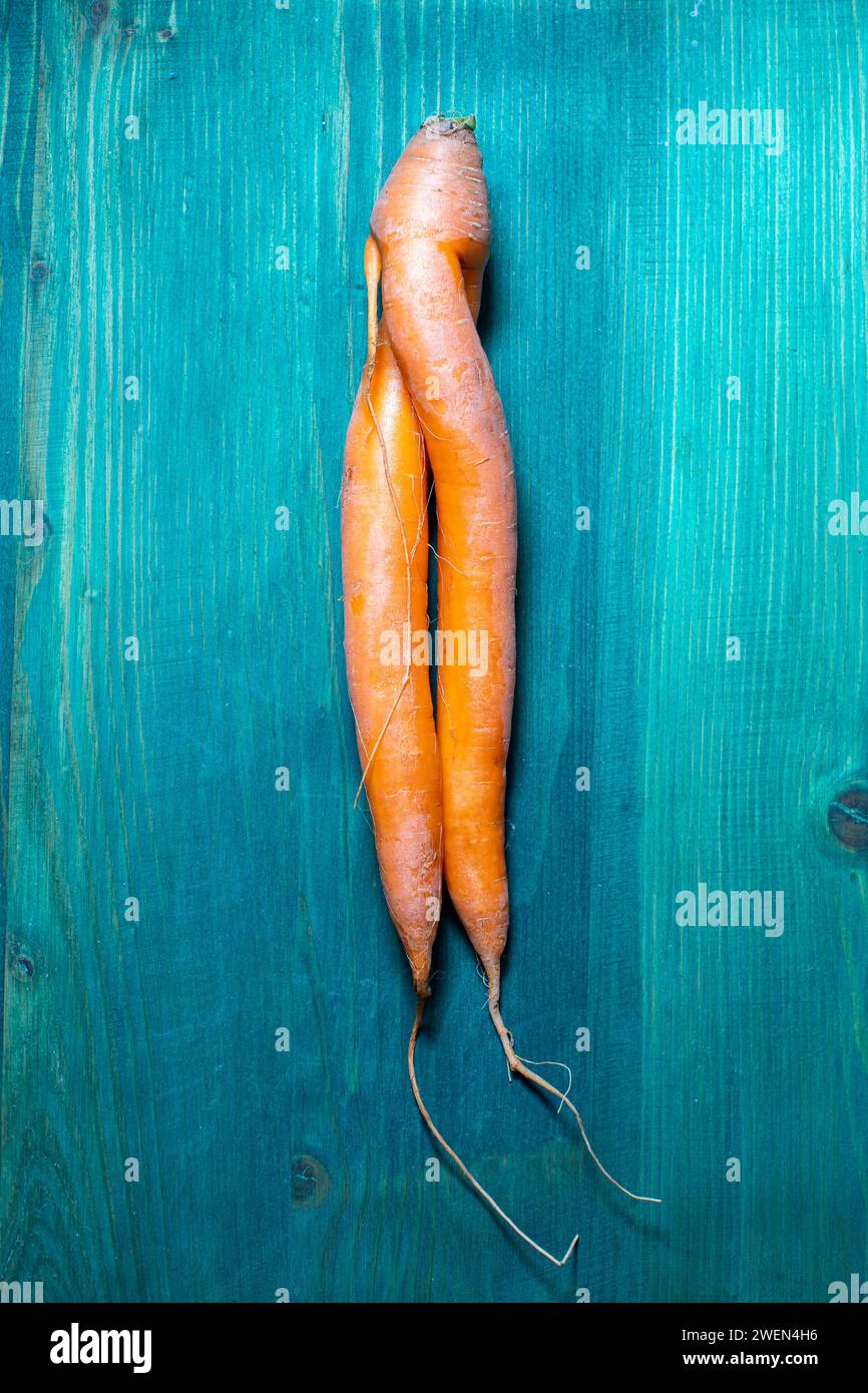 unusual carrot on wooden surface Stock Photo - Alamy