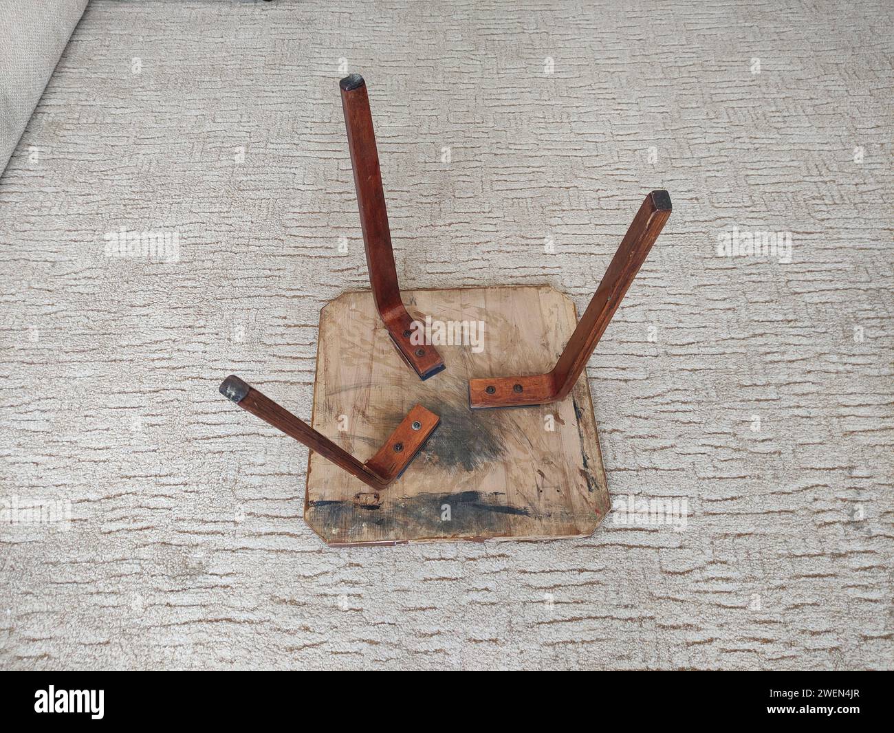 A homemade wooden three-legged magazine table Stock Photo - Alamy