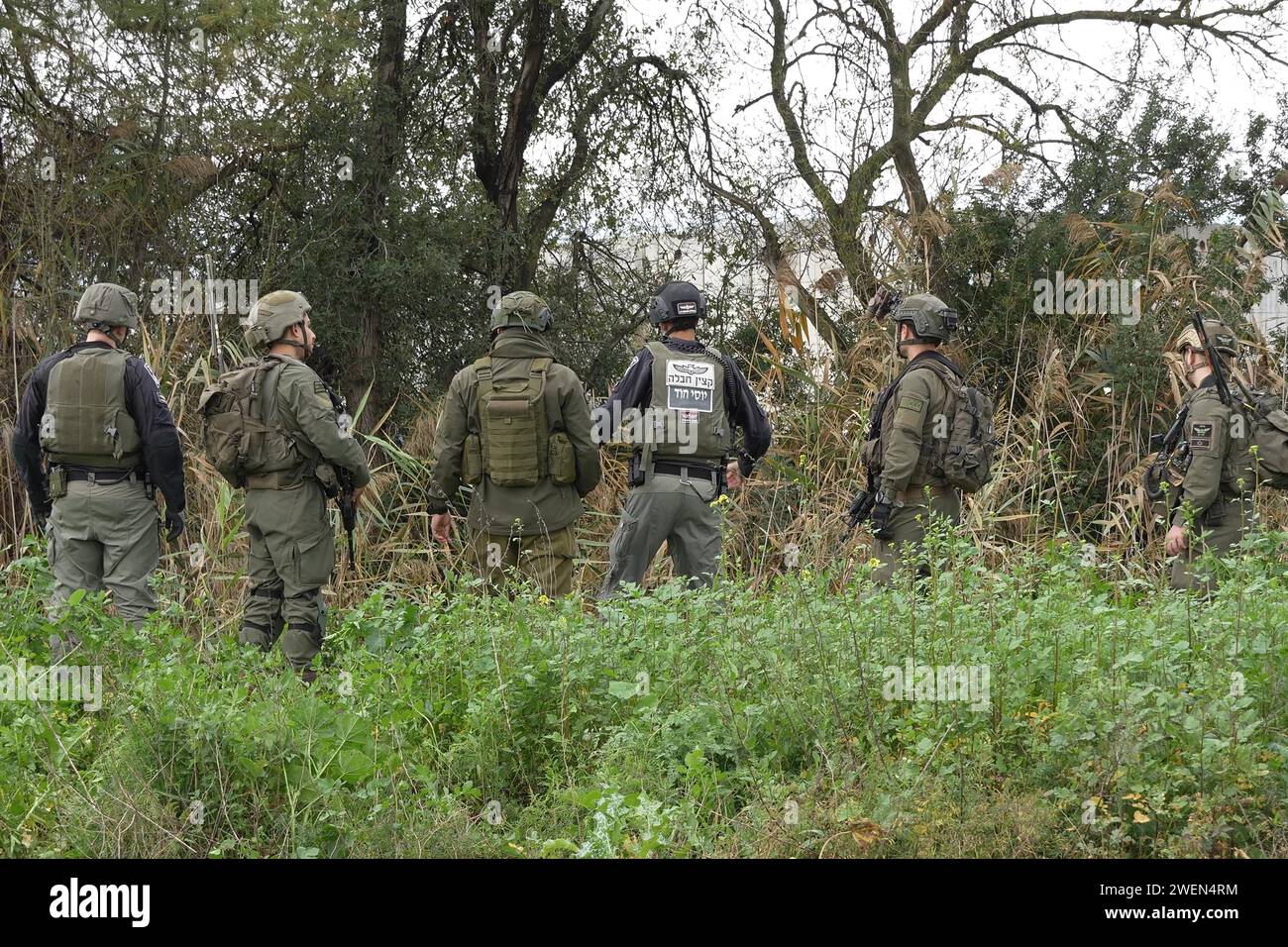 Israeli soldiers search a field after two explosive-laden drones were ...