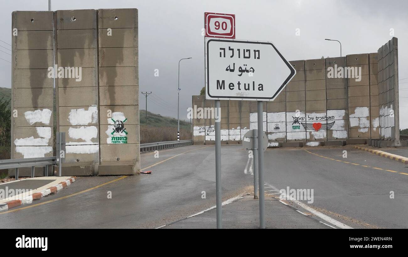 Security walls are placed on the way to the town of Metula situated ...