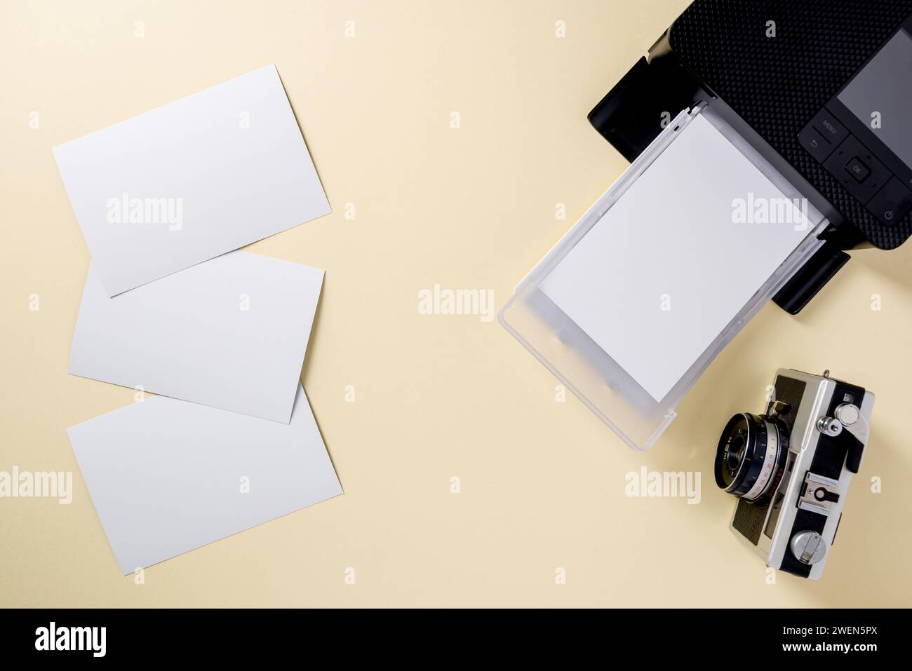 Top view of retro camera, blank photo papers and mobile photo printer ...