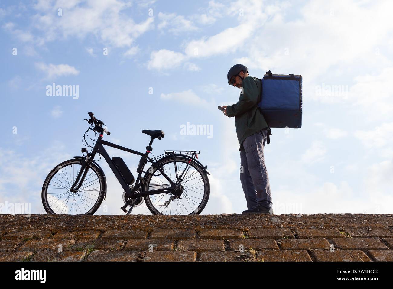 bicycle delivery person taking order over phone application Stock Photo ...