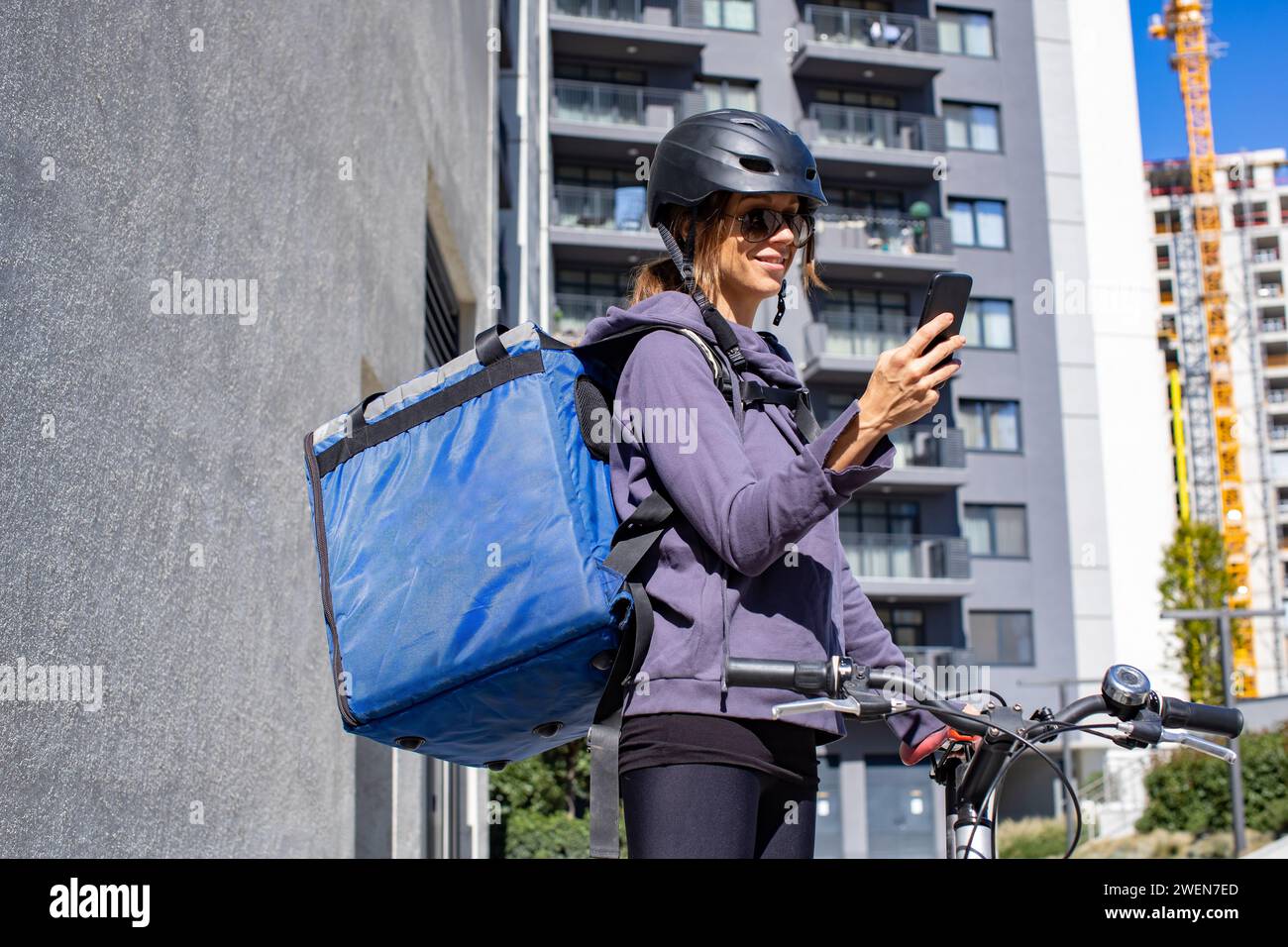 female delivery person receiving order Stock Photo - Alamy