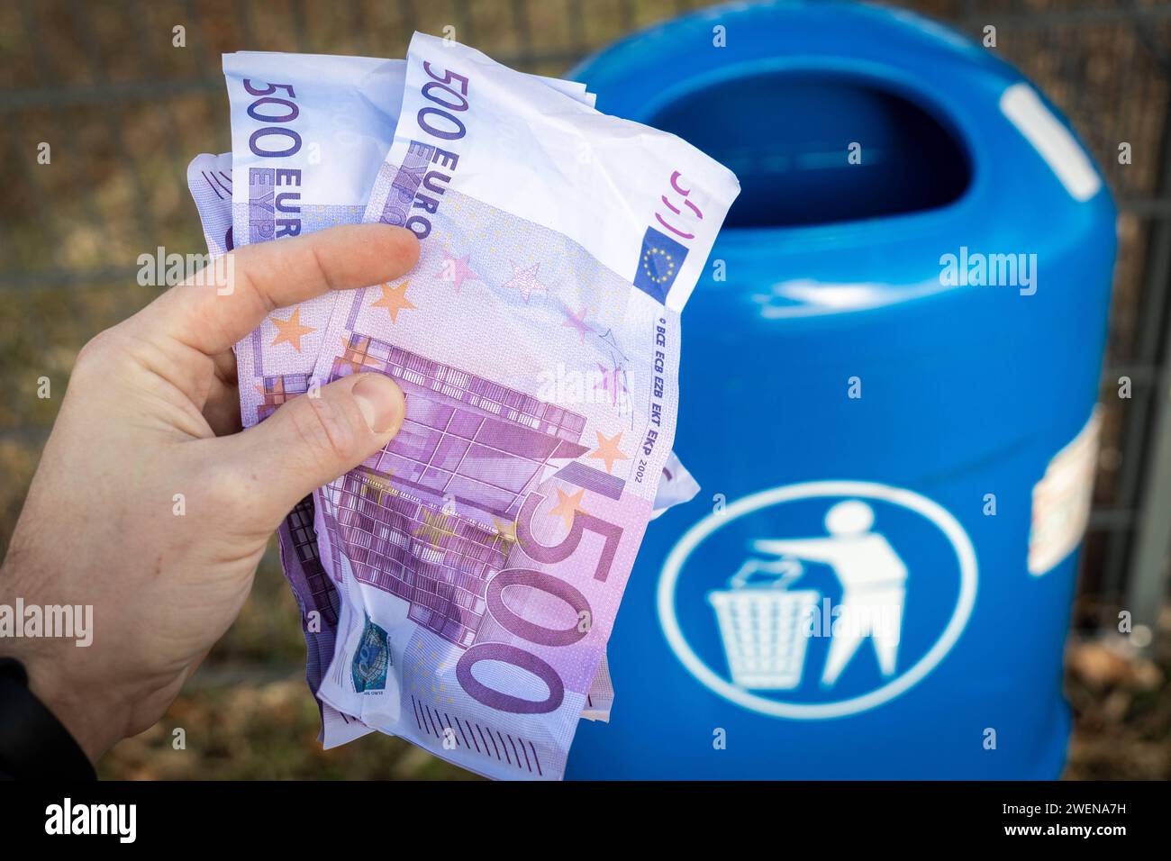 Langweid, Bavaria, Germany - January 26, 2024: Man throws euro cash ...