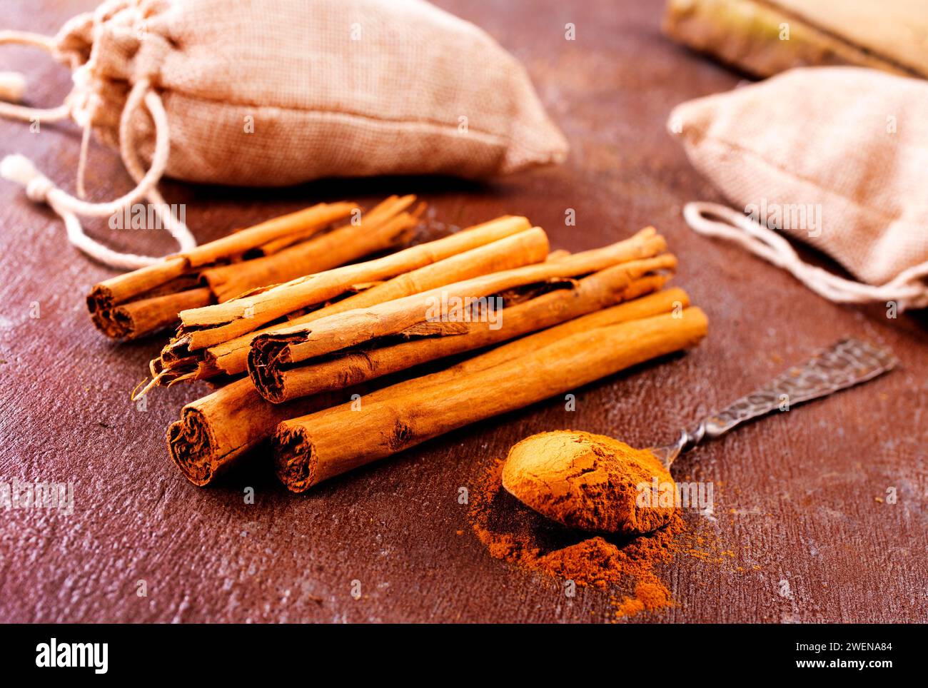 Cinnamon sticks on a wooden background. Cinnamon spice in a spoon and ...