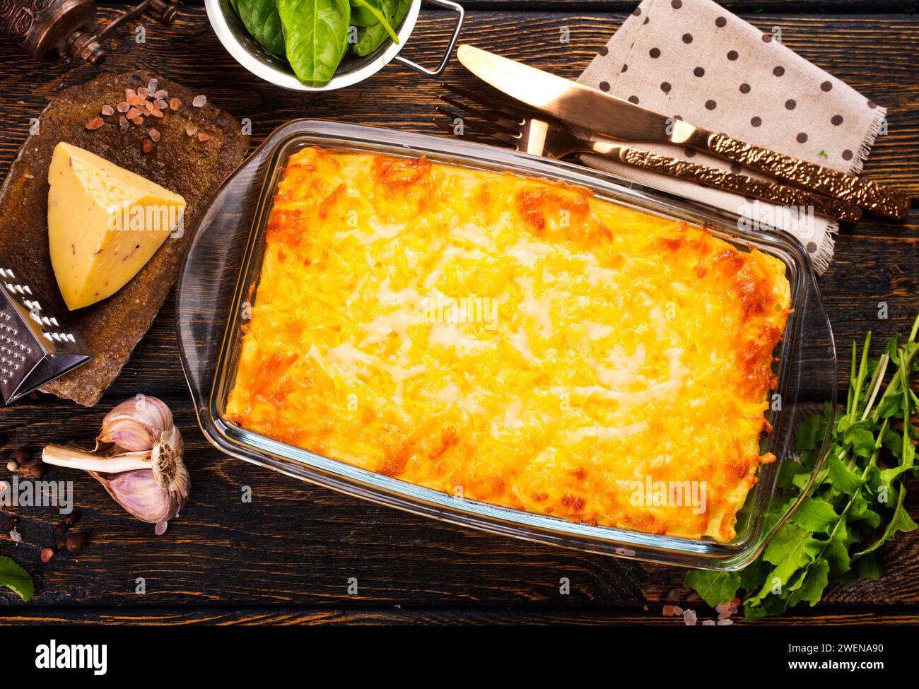 Rectangular glass bowl filled with mashed potato, underneath which is ...