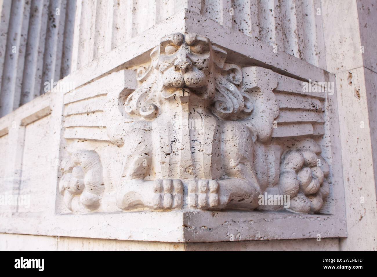 Detailed white stone bas-relief of a lion, an angular decoration in ...